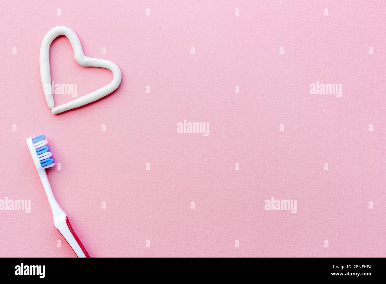 Teeth hygiene. Toothbrush with heart shape made of toothpaste, top view ...