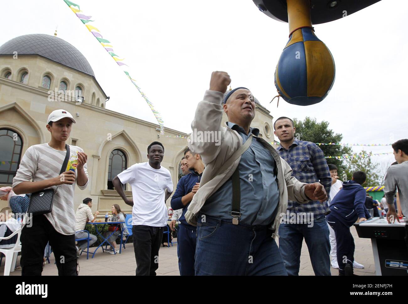 Muslim men have fun at the Ar-Rahma Mosque during the celebration. Eid ...