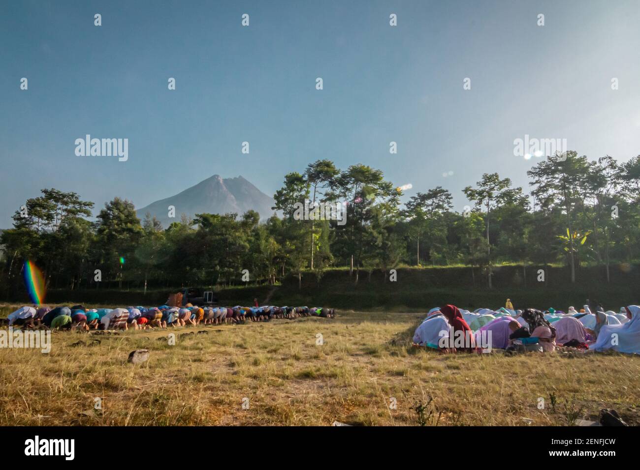 Indonesian Muslims perform Eid al-Adha prayer with background Mount ...