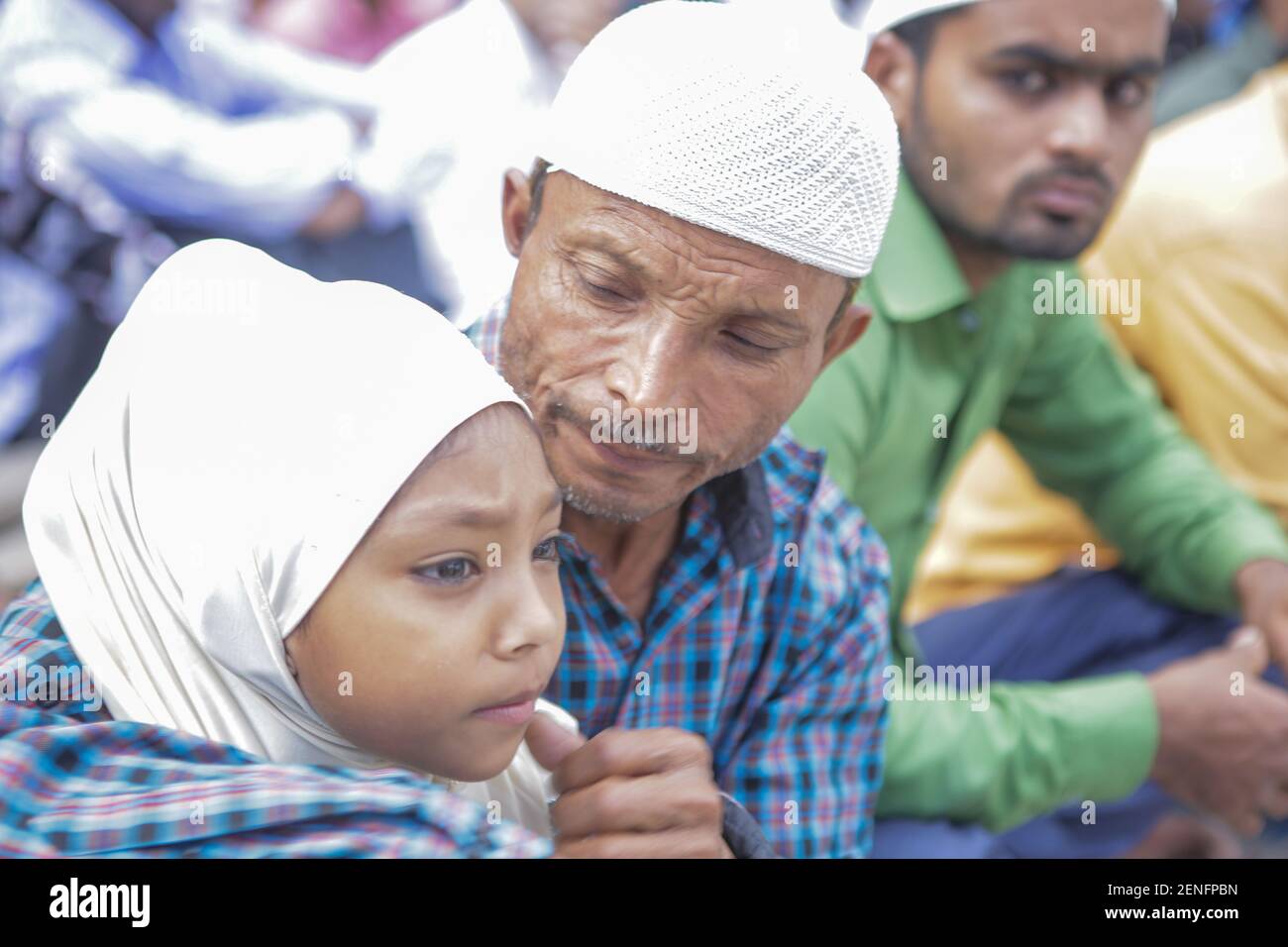 A Muslim man with her daughter attend Eid Al Adha prayers at the Takiya ...