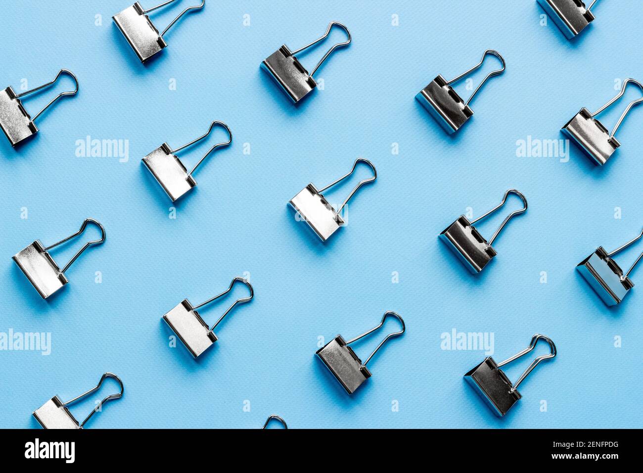 Flat lay of paper binder clips, office supplies pattern Stock Photo - Alamy