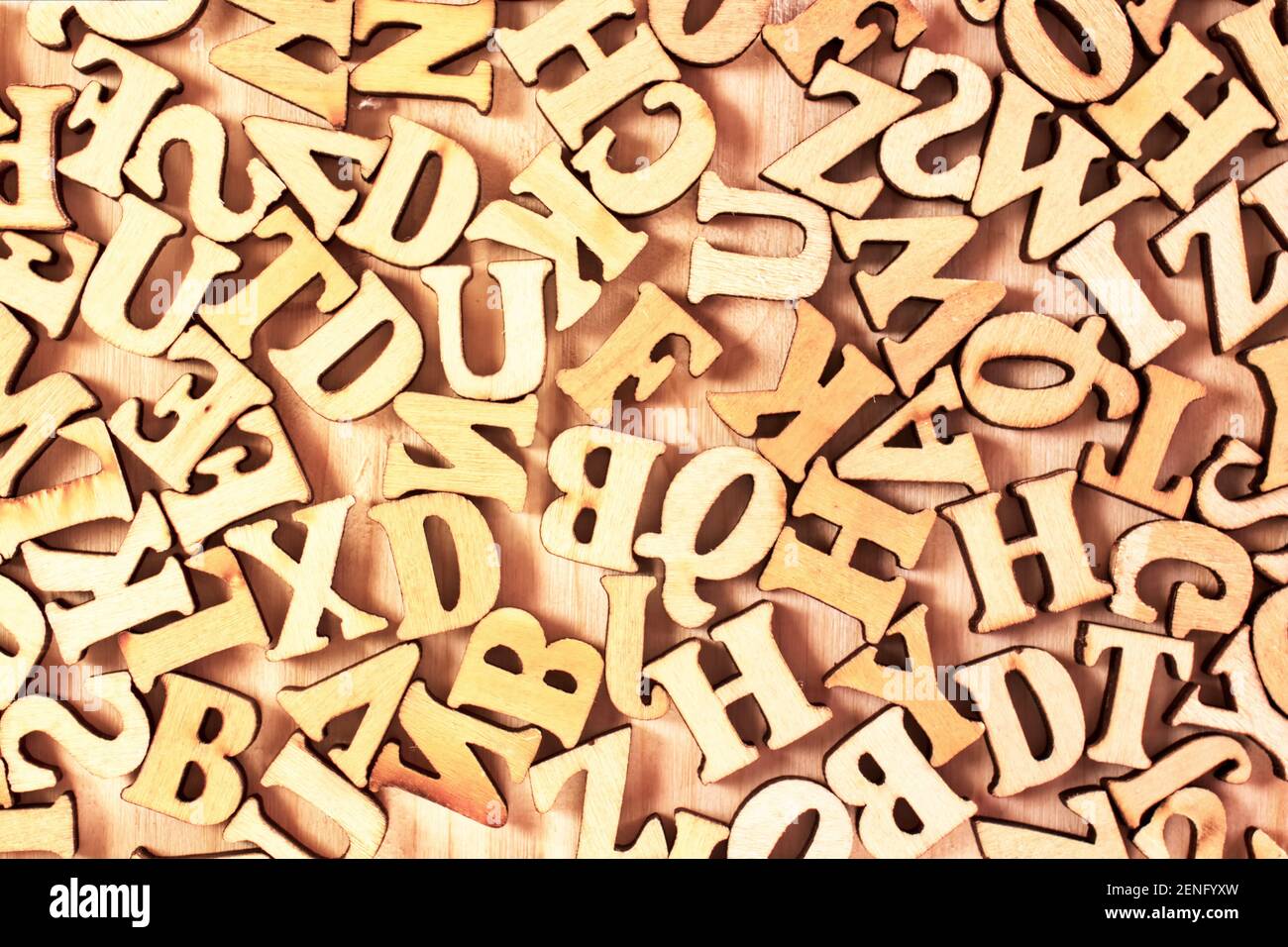 English alphabet. Wooden letters on a wooden background. A letter mess ...