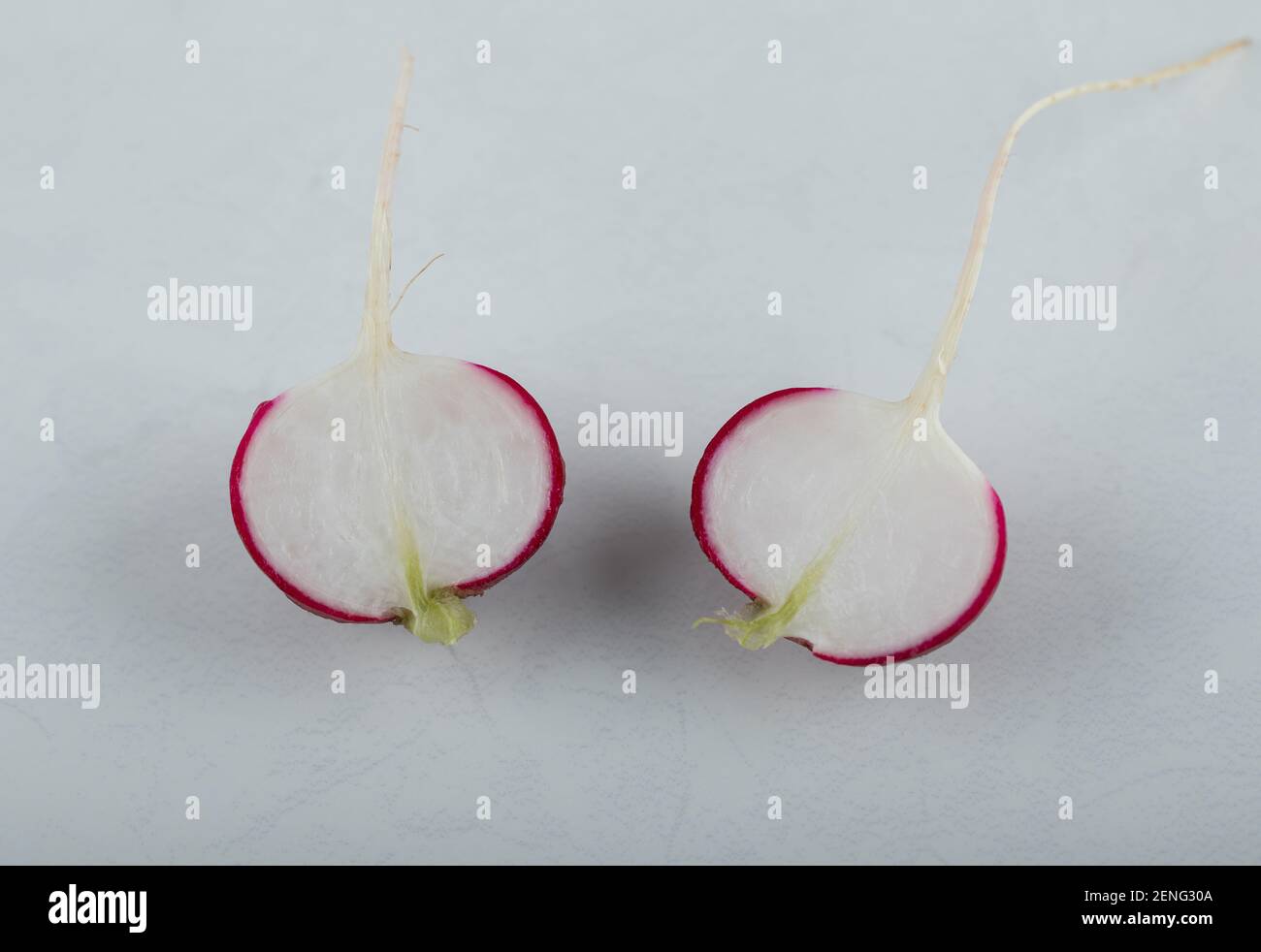 Half cut fresh radish on white background Stock Photo - Alamy