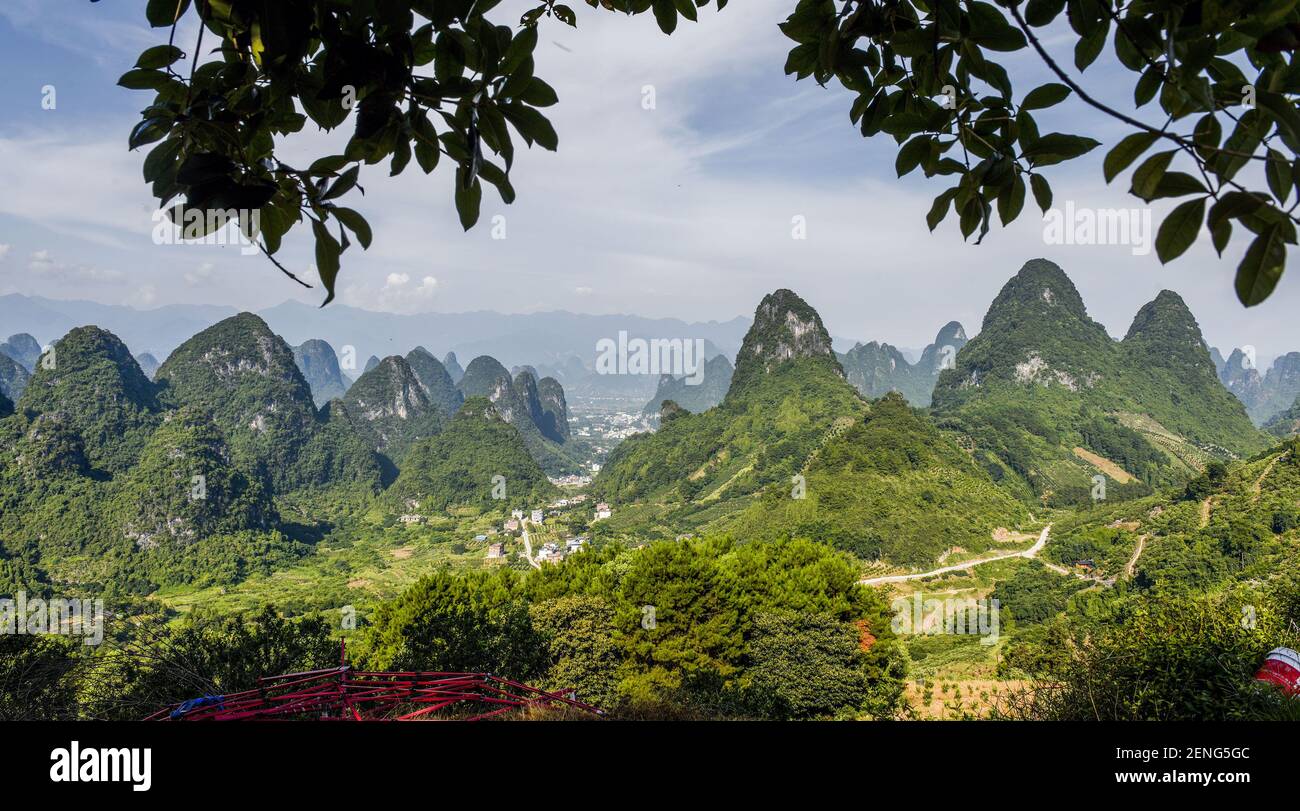 The mountains and hills are surrounded by mist and cloud along the Li ...