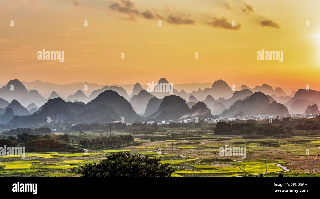 The mountains and hills are surrounded by mist and cloud along the Li ...