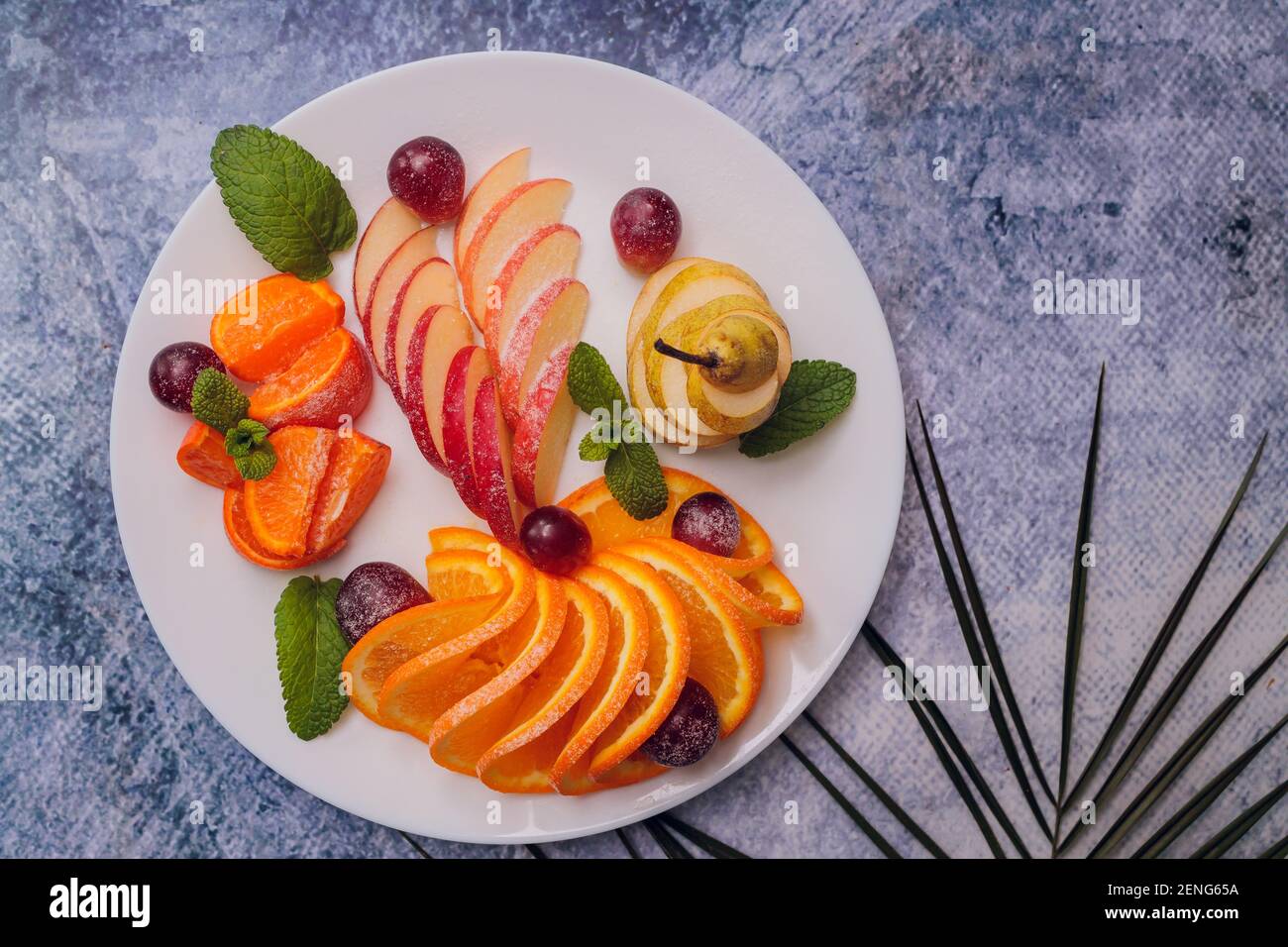 Assorted sliced tropical fruits on plate hi-res stock photography and ...