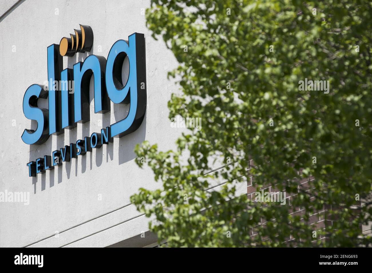 A logo sign outside of a facility occupied by Sling Television in ...