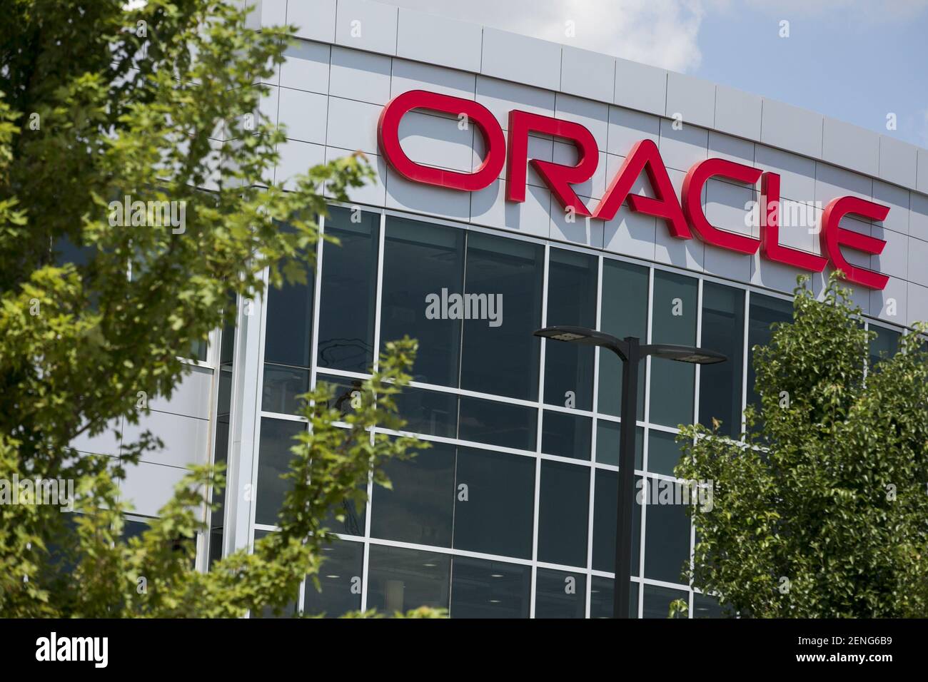 A logo sign outside of a facility occupied by the Oracle Corporation in ...