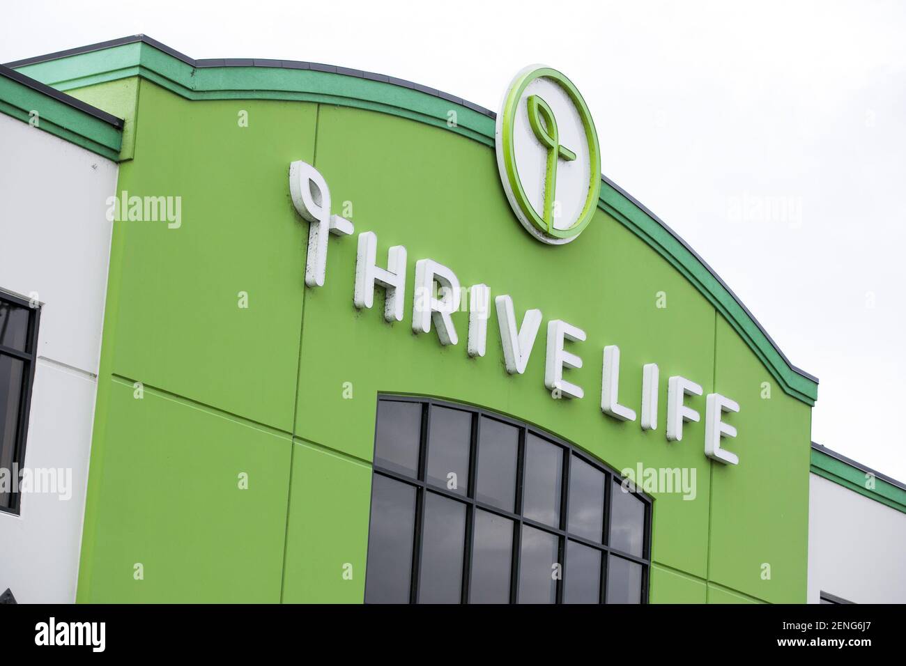 A logo sign outside of the headquarters of Thrive Life in American Fork ...