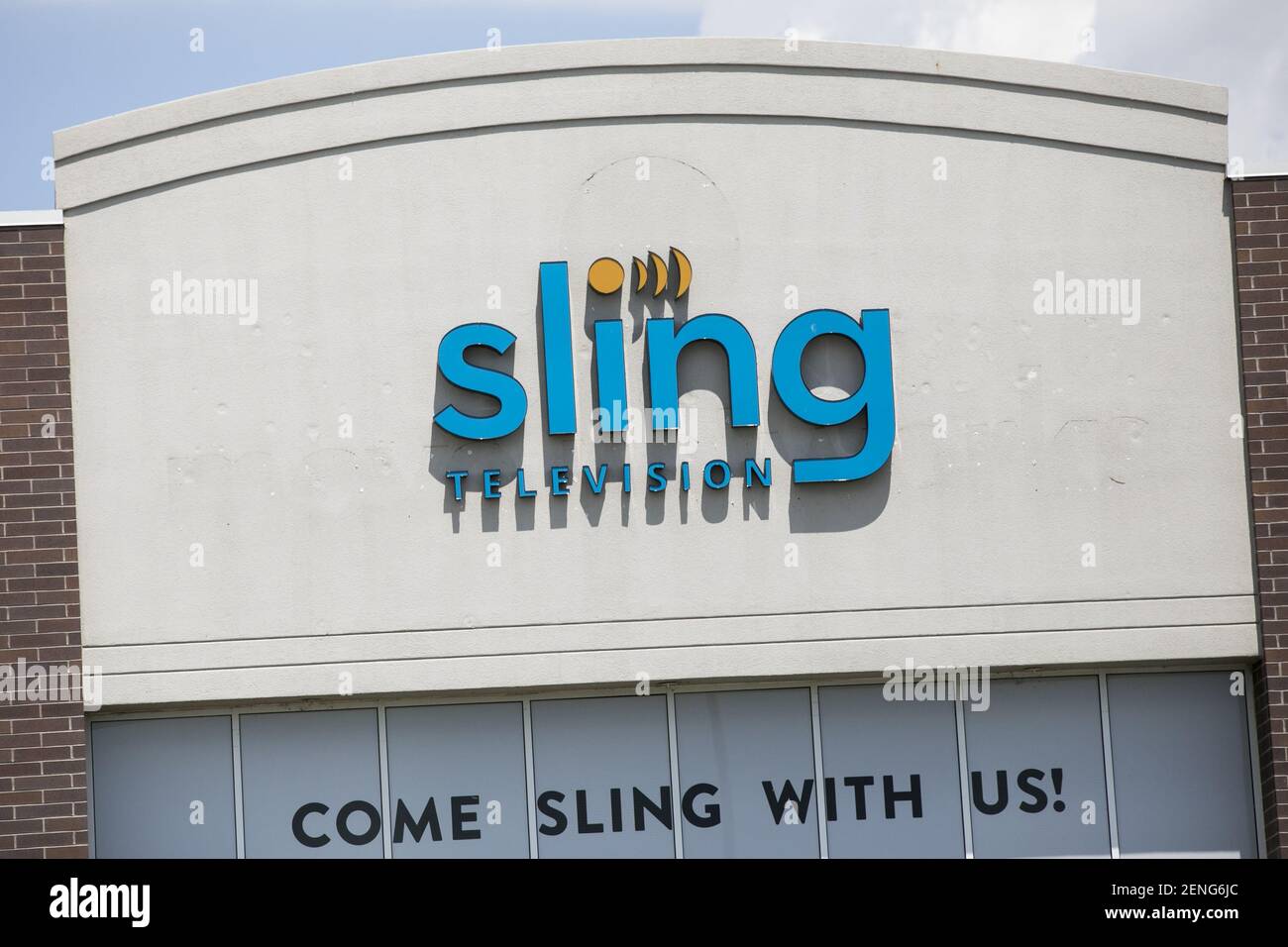 A logo sign outside of a facility occupied by Sling Television in ...