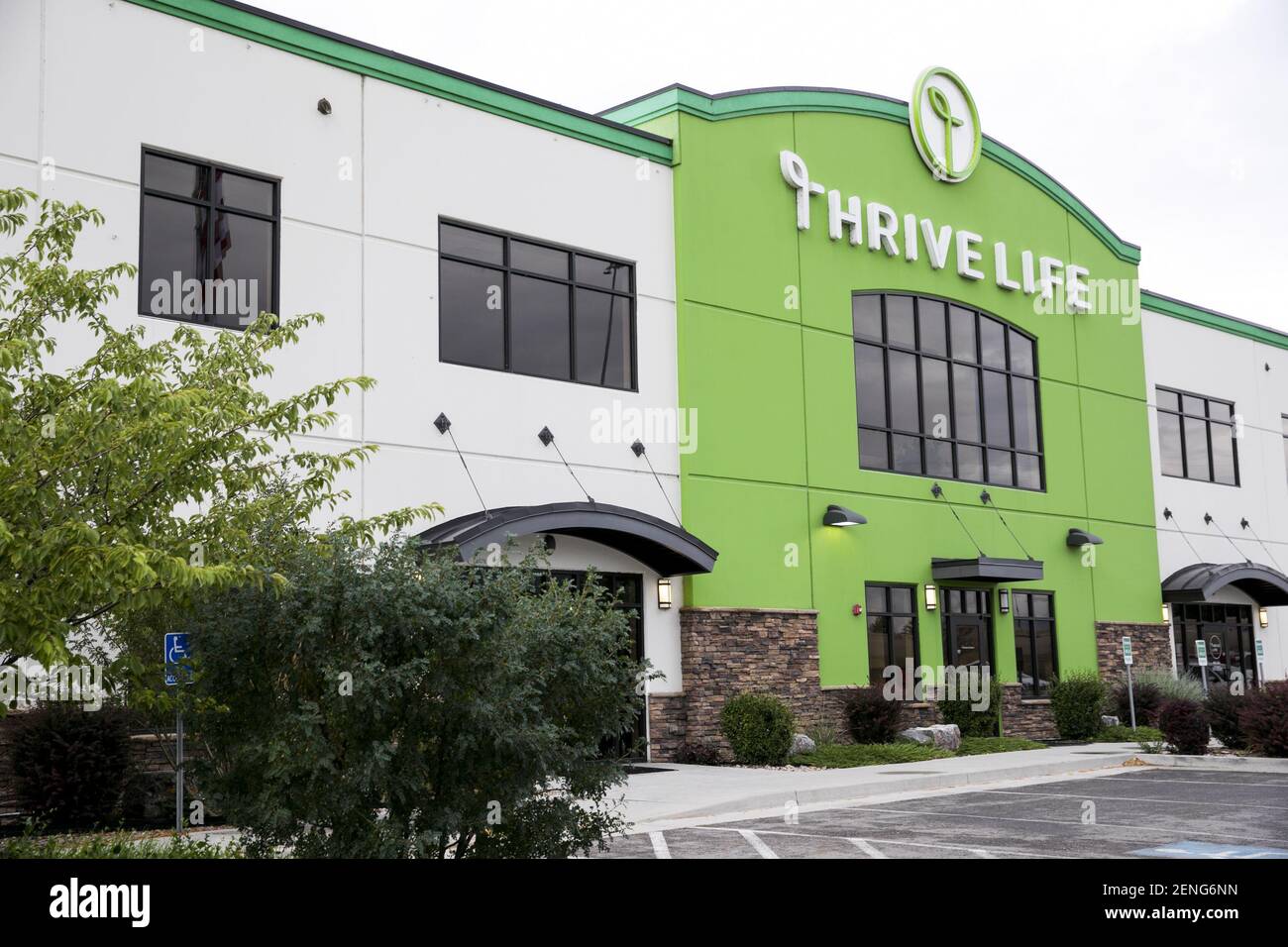 A logo sign outside of the headquarters of Thrive Life in American Fork ...