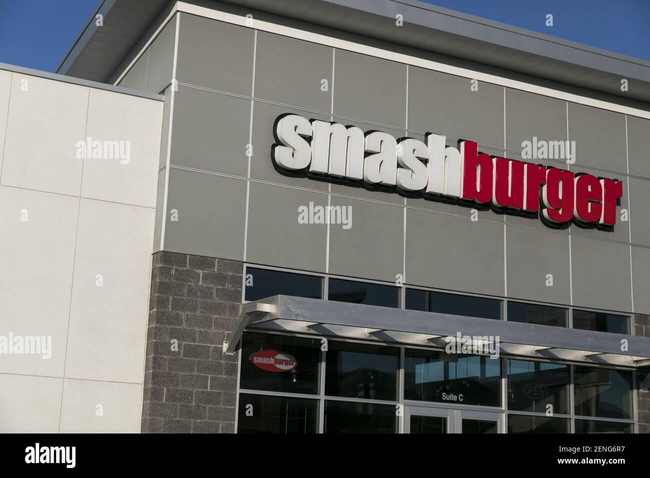 A logo sign outside of a Smashburger restaurant location in Lehi, Utah ...