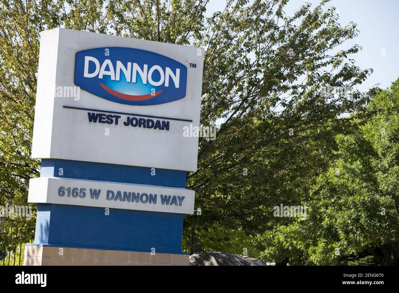 A logo sign outside of a facility occupied by Dannon in West Jordan ...