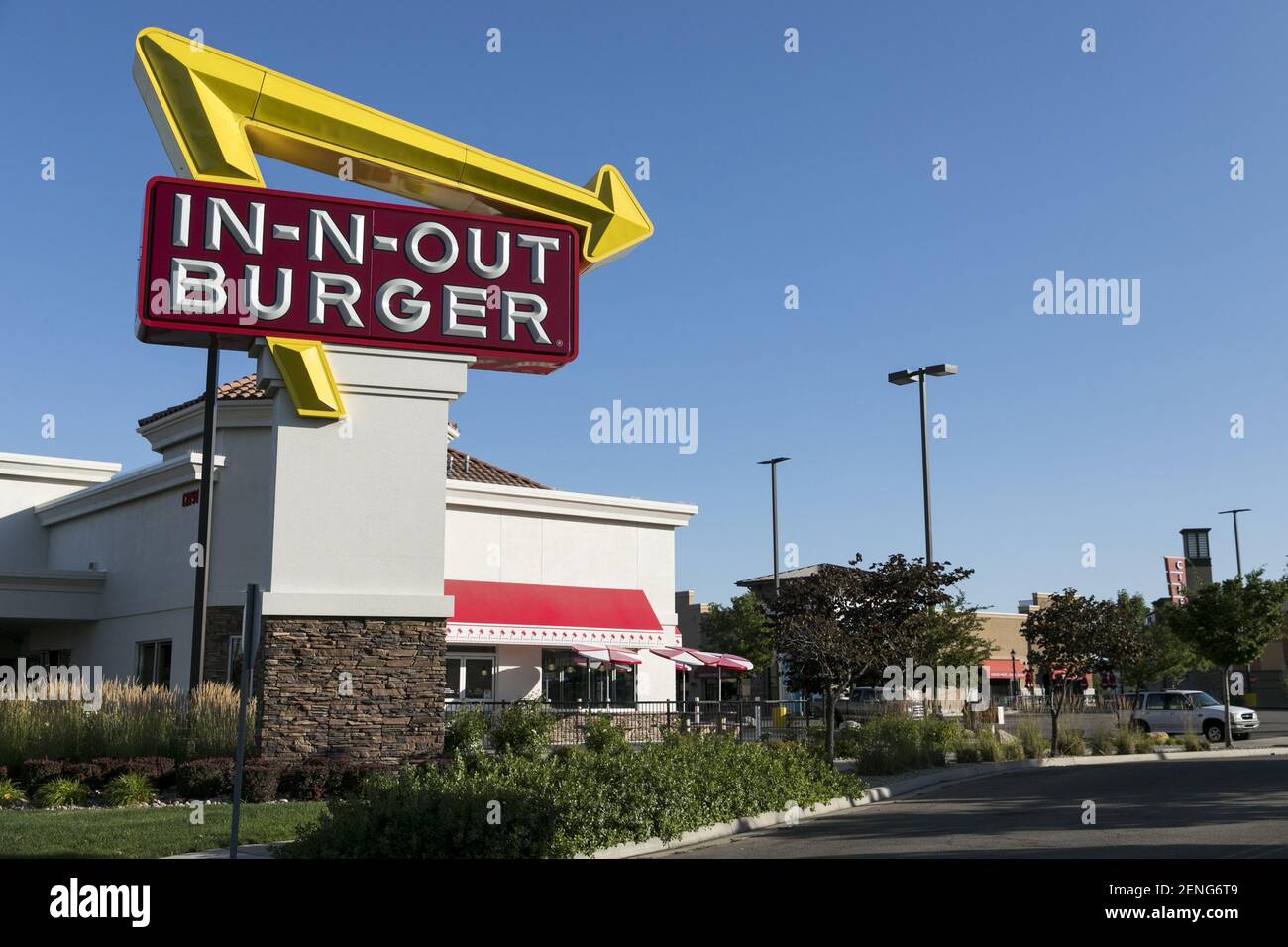 A logo sign outside of a In-N-Out Burger fast food restaurant location ...