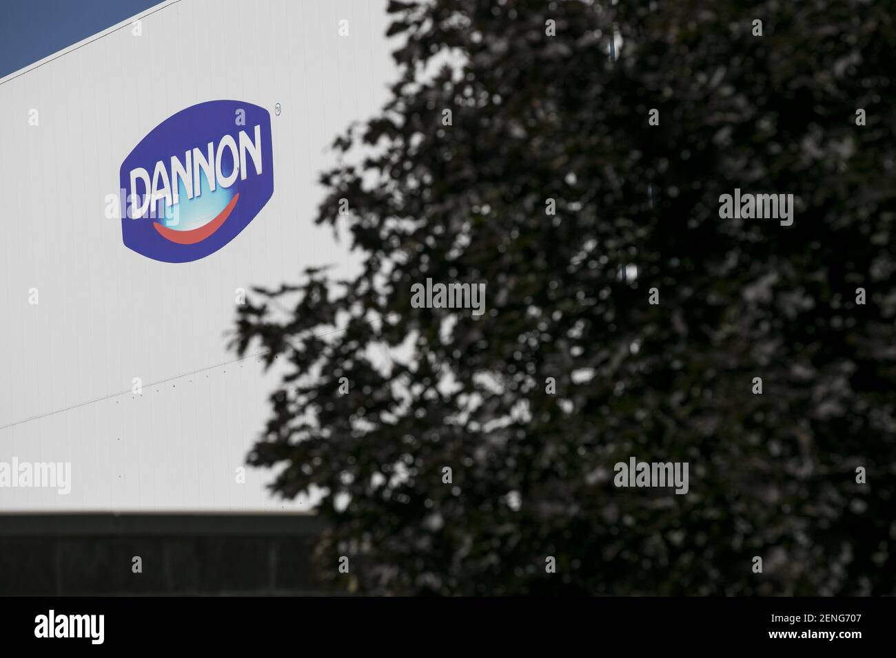 A logo sign outside of a facility occupied by Dannon in West Jordan ...