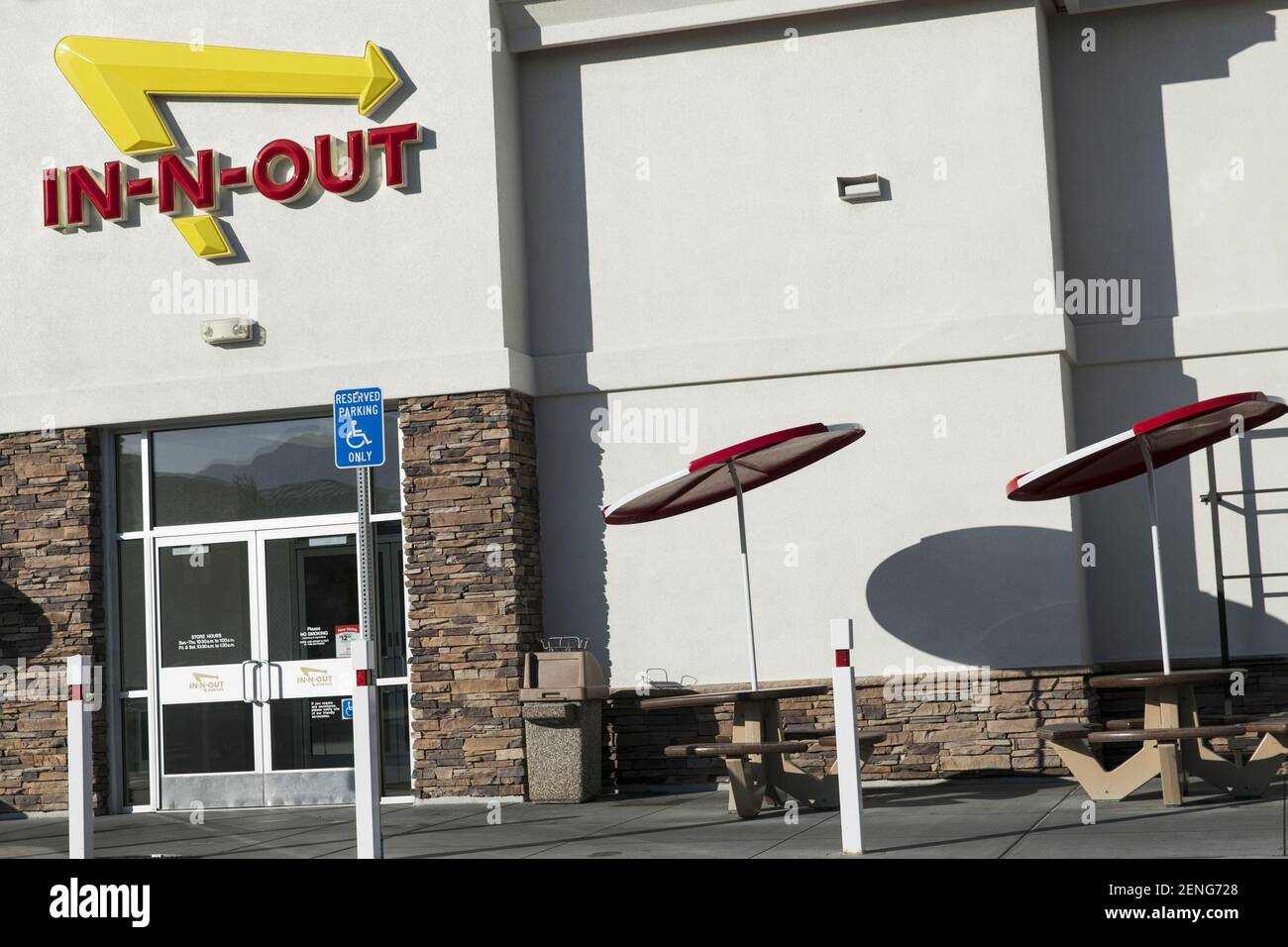 A logo sign outside of a In-N-Out Burger fast food restaurant location ...