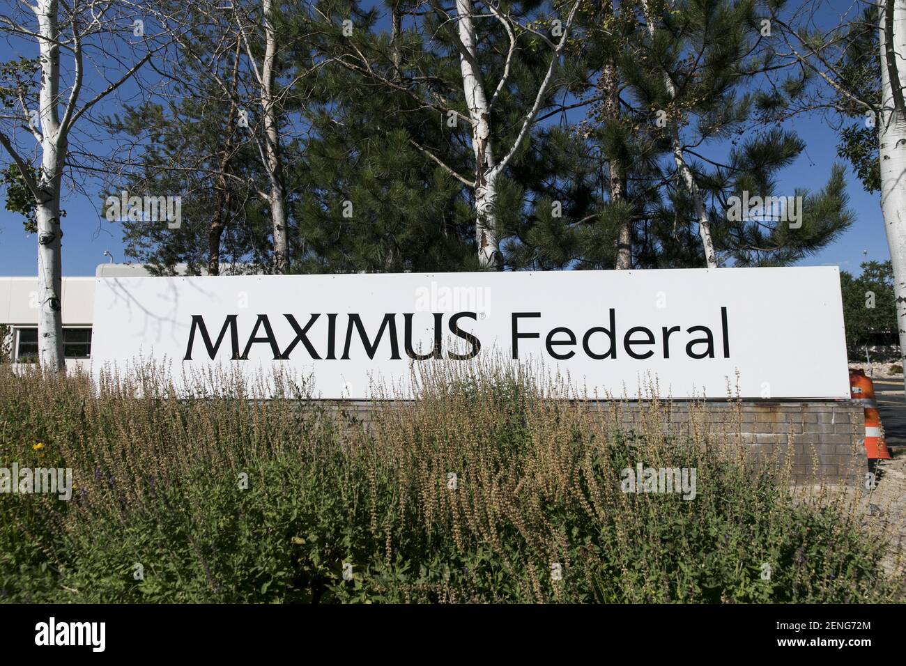 A logo sign outside of a facility occupied by MAXIMUS Federal in Sandy ...