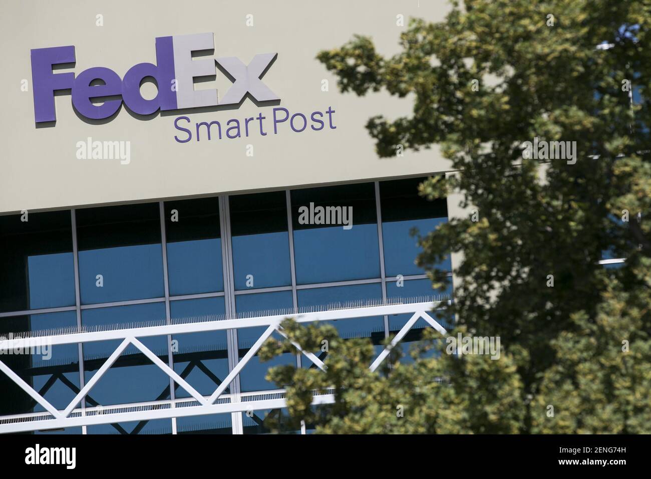 A logo sign outside of a facility occupied by FedEx SmartPost in Salt ...