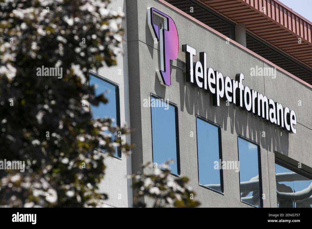 A logo sign outside of a facility occupied by Teleperformance in Salt ...