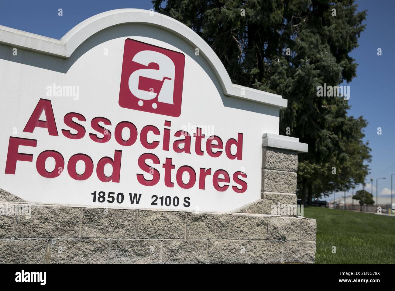 A logo sign outside of the headquarters of Associated Food Stores in ...