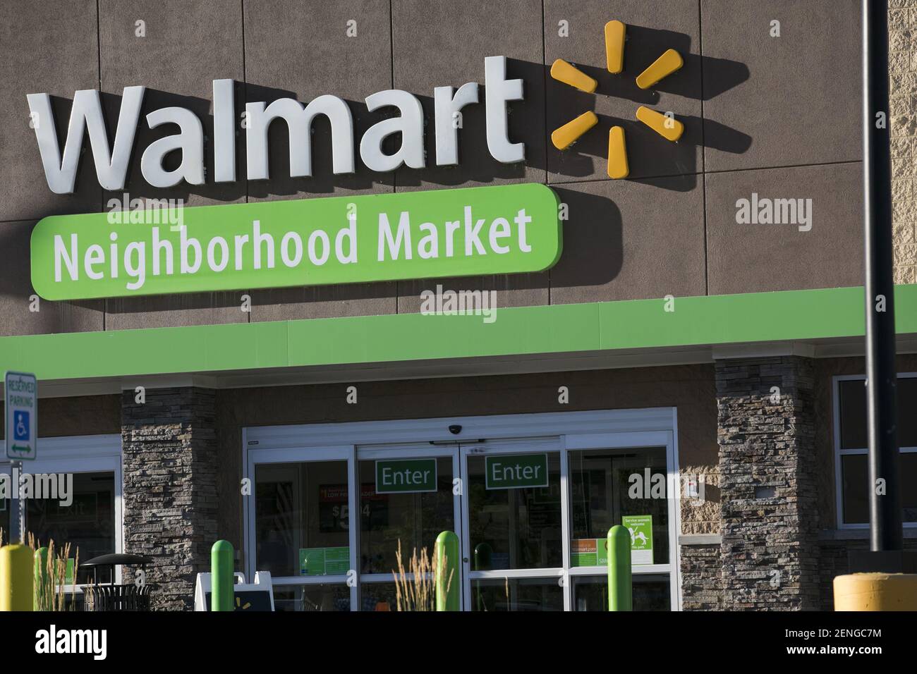 A logo sign outside of a Walmart Neighborhood Market retail store ...