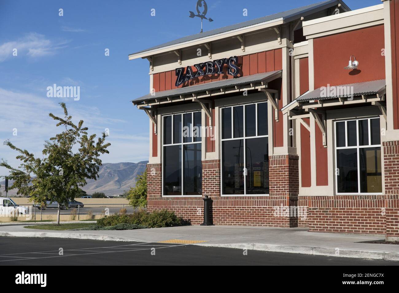 A logo sign outside of a Zaxby's fast food restaurant location in ...