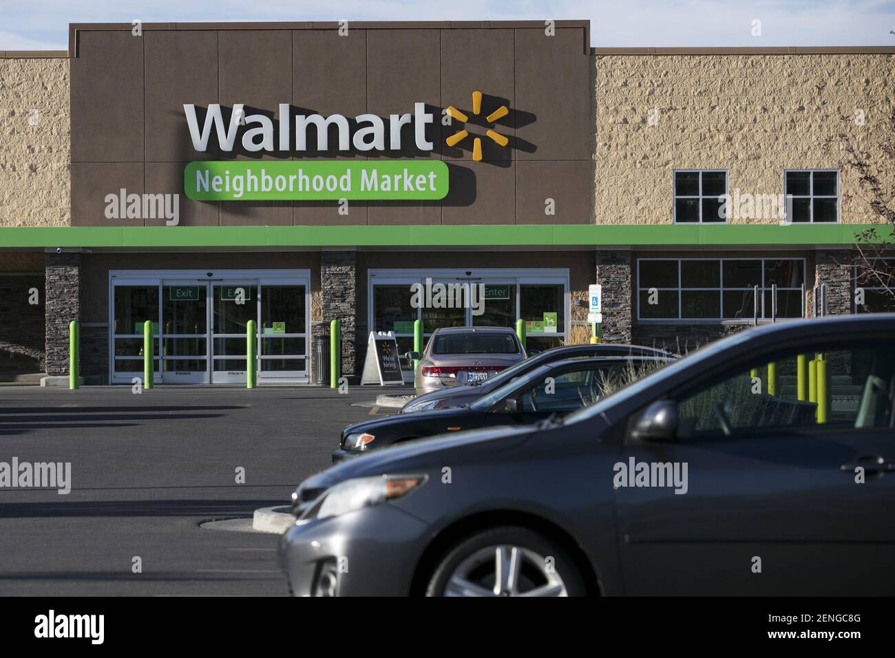 A logo sign outside of a Walmart Neighborhood Market retail store ...