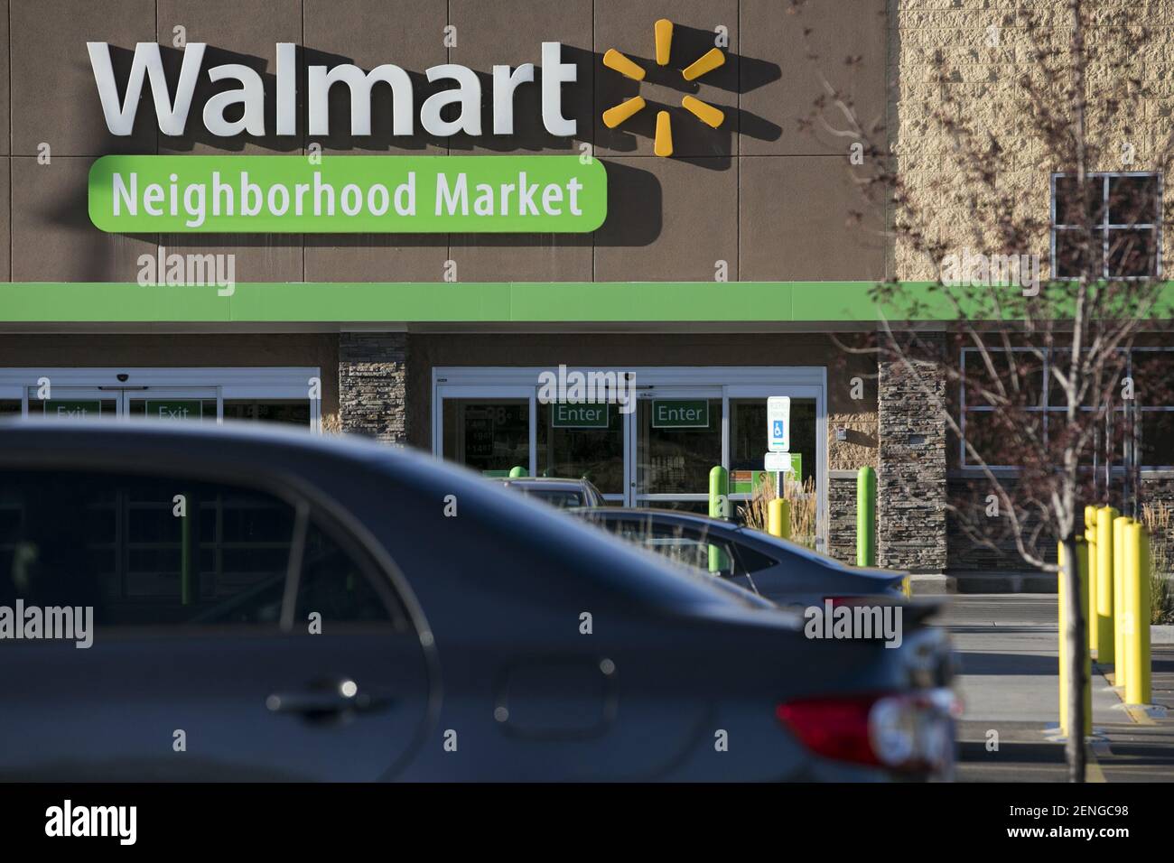 A logo sign outside of a Walmart Neighborhood Market retail store ...