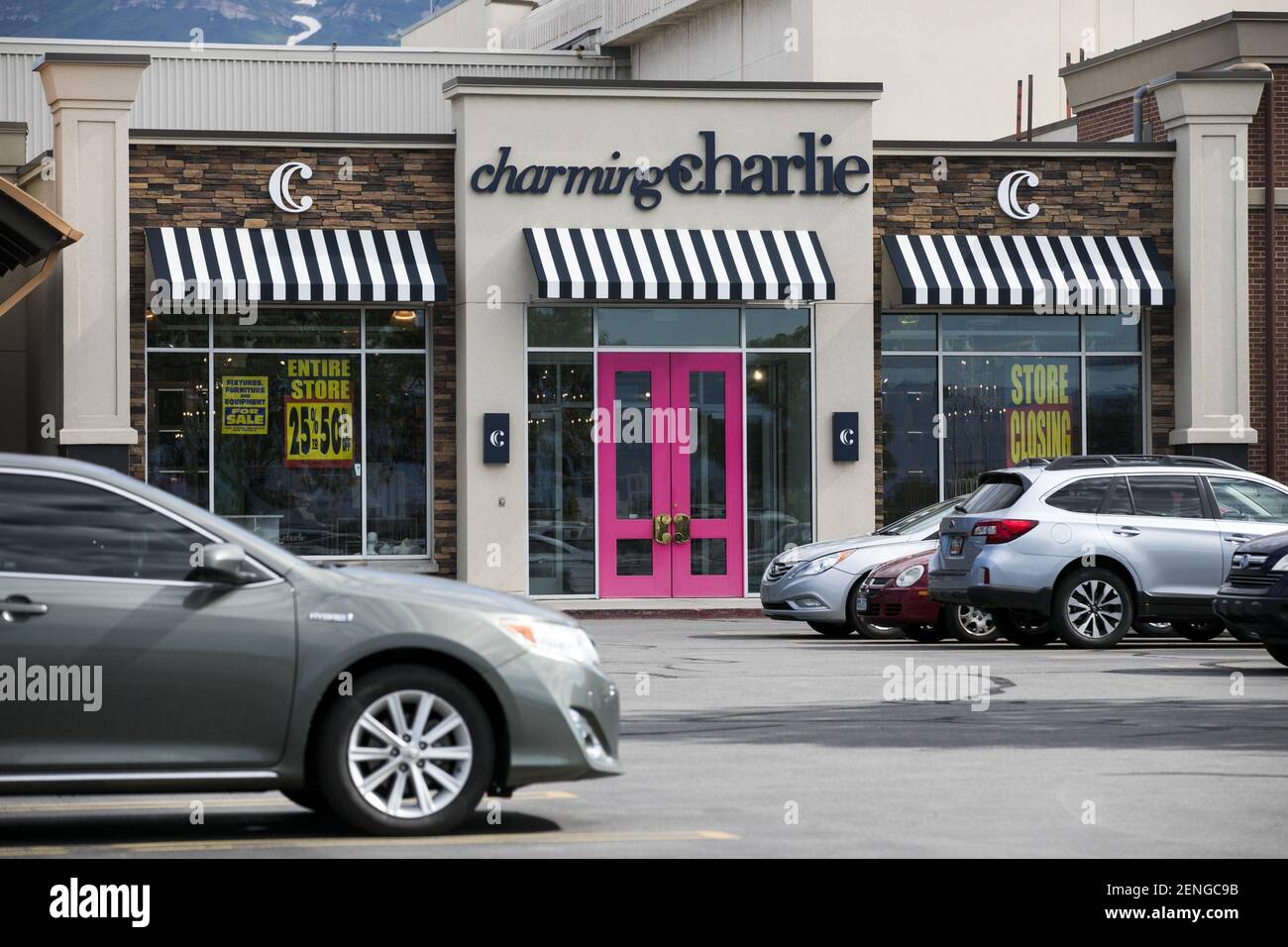 A logo and 'store closing' signs outside of a Charming Charlie retail ...