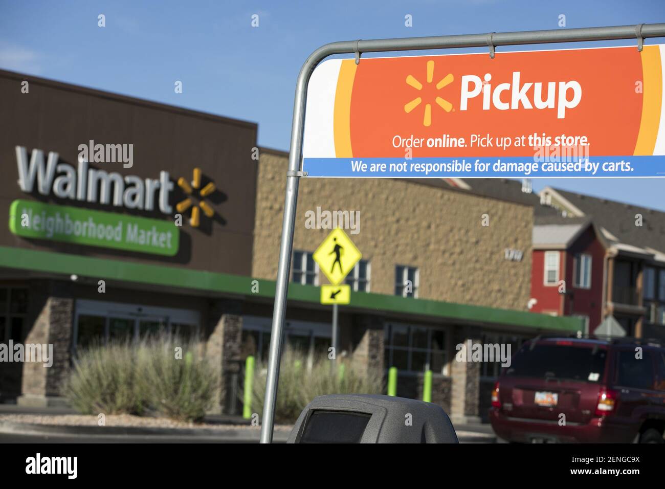 A logo sign outside of a Walmart Neighborhood Market retail store ...