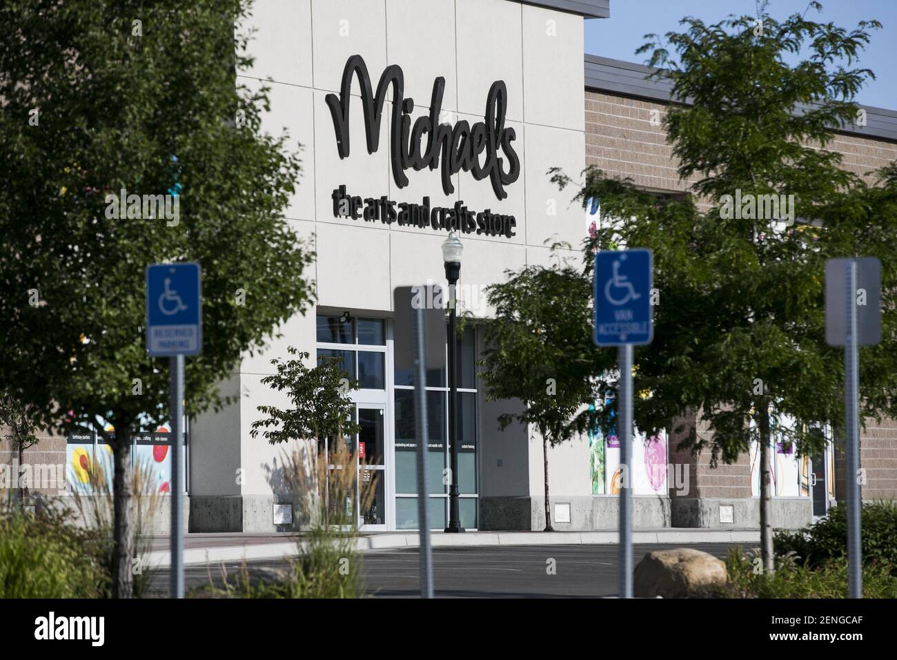 A logo sign outside of a Michaels retail store location in American ...