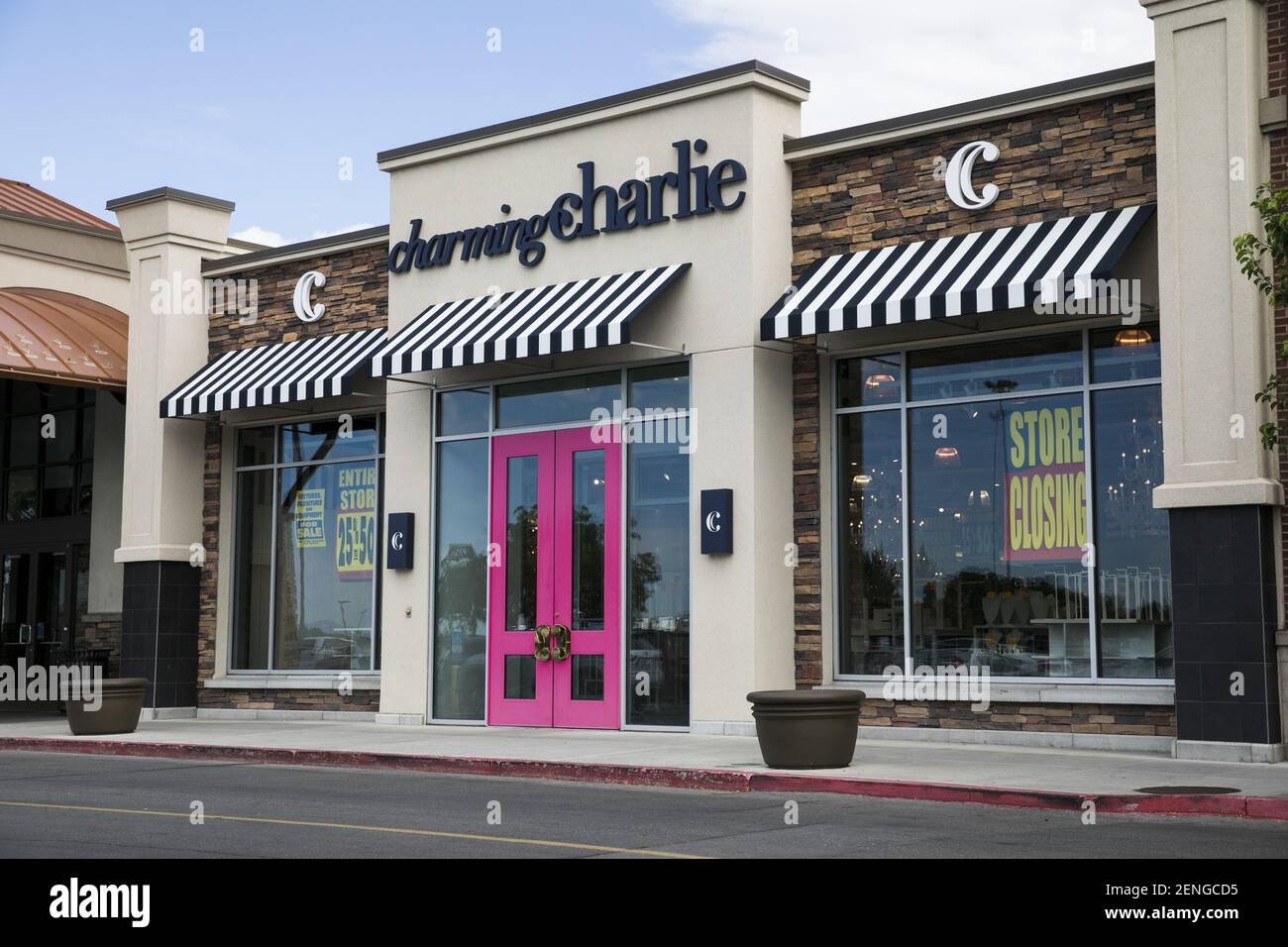 A logo and 'store closing' signs outside of a Charming Charlie retail ...