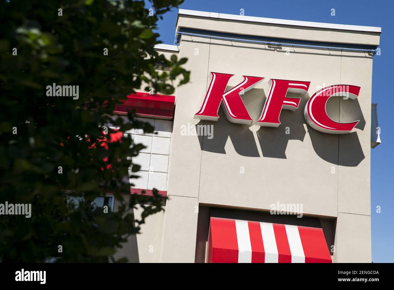 A logo sign outside of the first Kentucky Fried Chicken (KFC) franchise ...