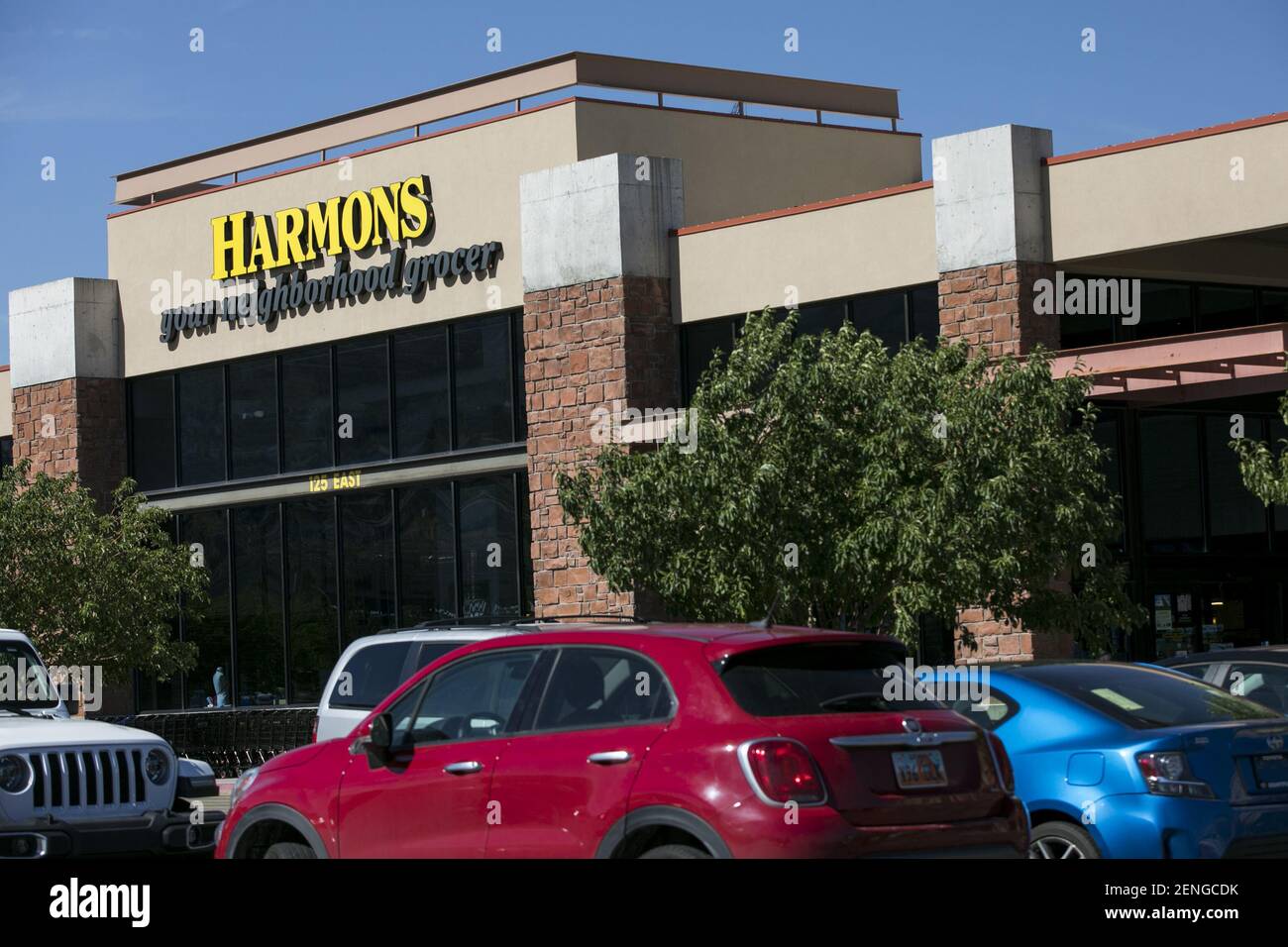 A logo sign outside of a Harmons retail grocery store location in Lehi ...