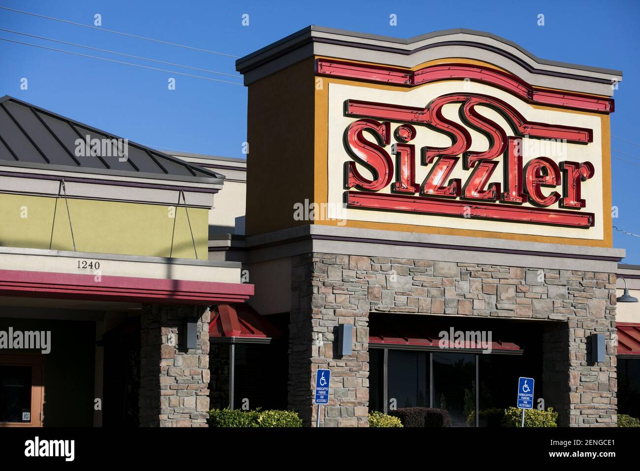 A logo sign outside of a Sizzler restaurant location in Orem, Utah on ...