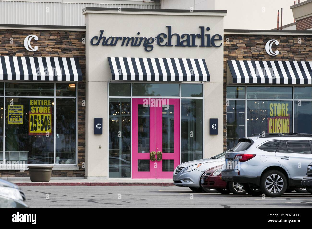A logo and 'store closing' signs outside of a Charming Charlie retail ...