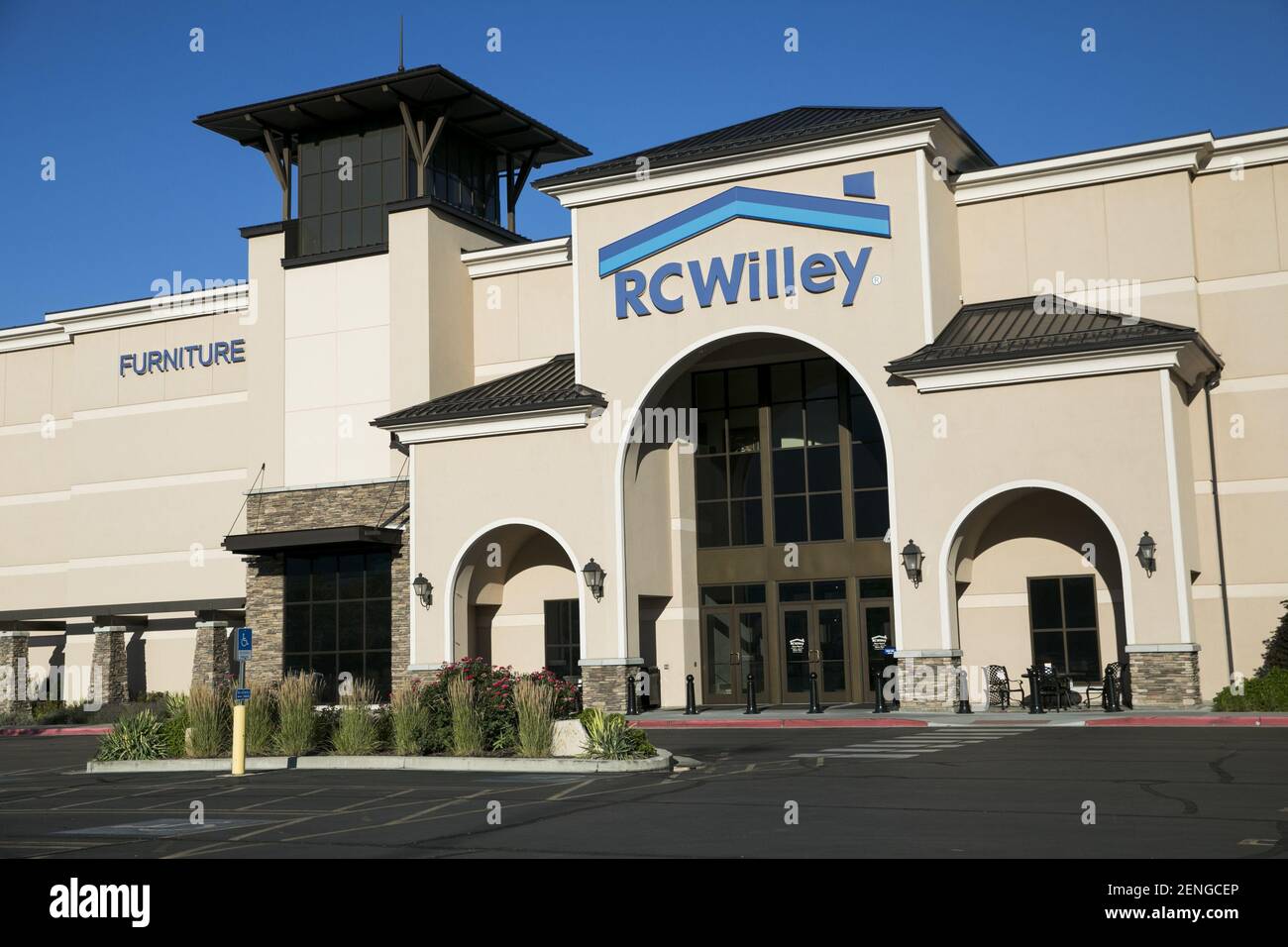 A logo sign outside of a RC Willey Home Furnishings retail store ...