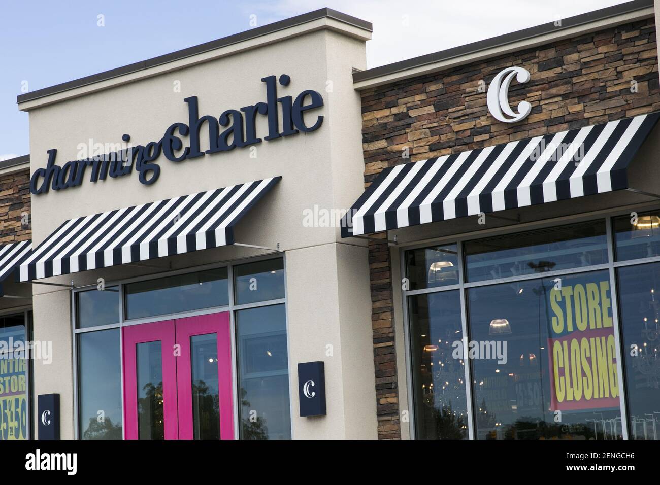 A logo and 'store closing' signs outside of a Charming Charlie retail ...