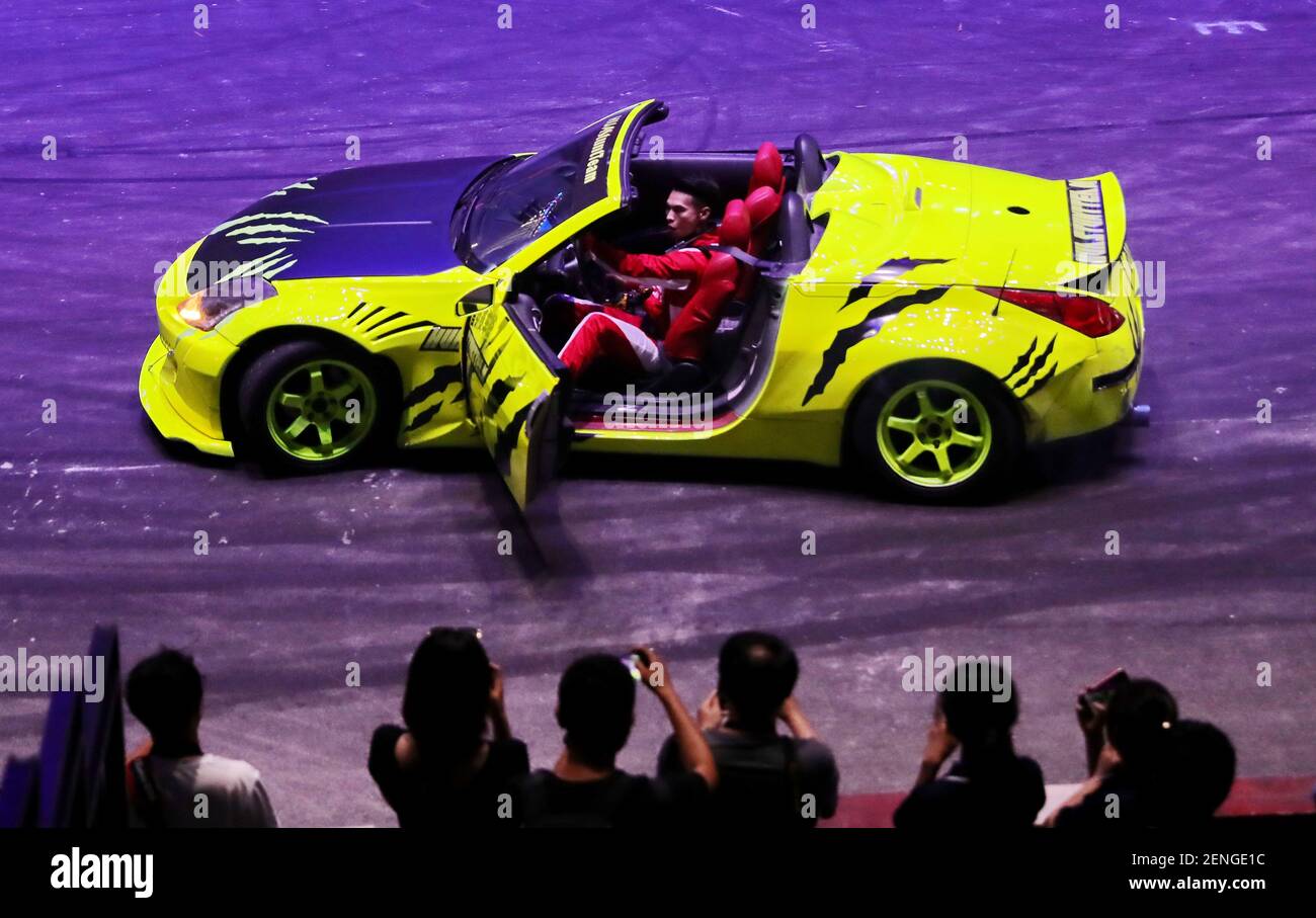 Members of car racing acrobatic teams perform during the reopening ...