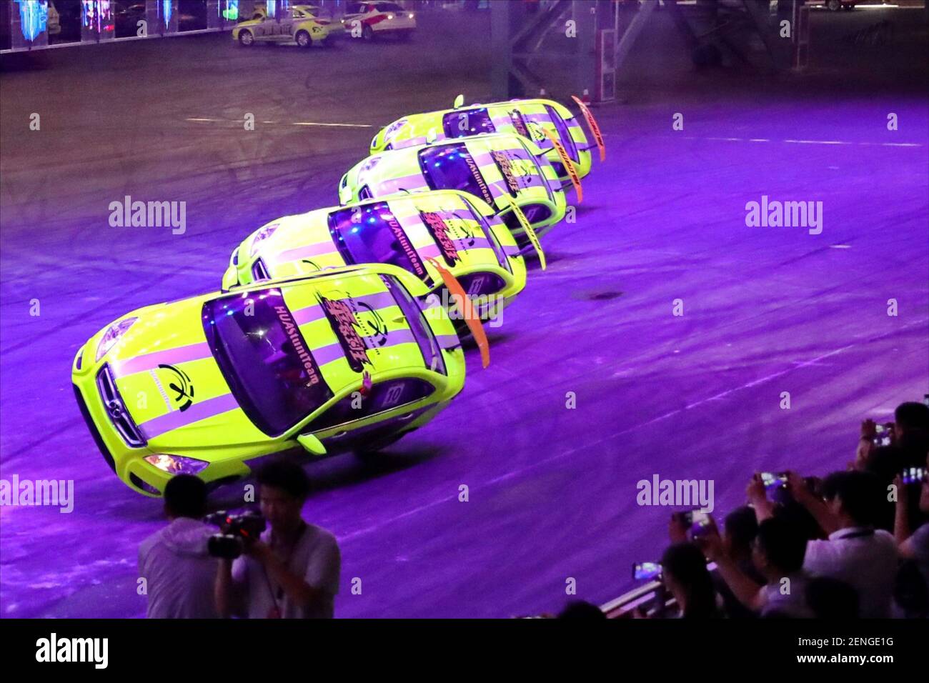 Members of car racing acrobatic teams perform during the reopening ...