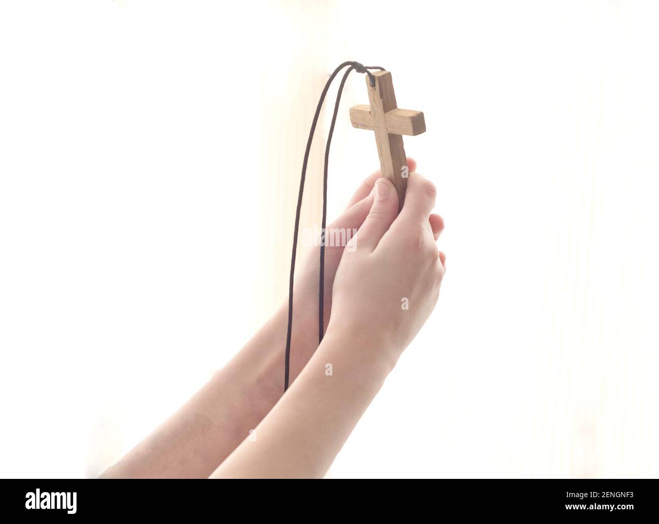 Bible praying hands holding cross hi-res stock photography and images ...