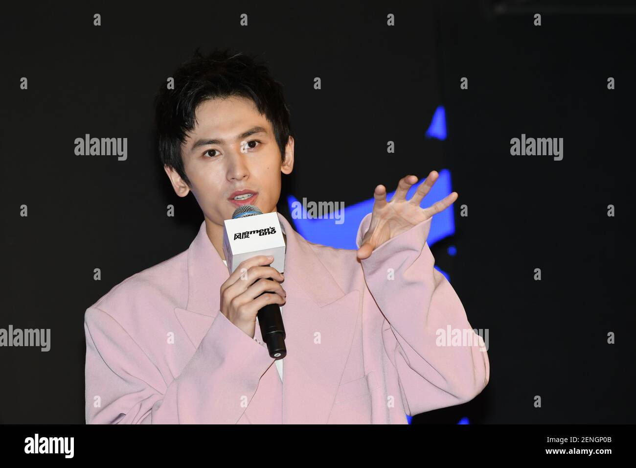 Chinese actor Zhang Zhehan, wearing pink suit, interacts with concert ...