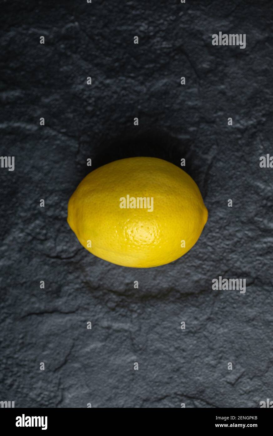 Vertical photo of fresh ripe lemon on the black background Stock Photo ...