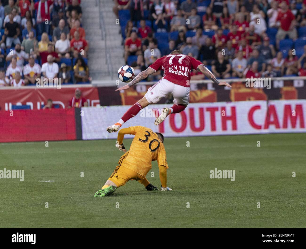 Daniel Royer (77) of Red Bulls jumps over goalkeeper during regular MLS ...