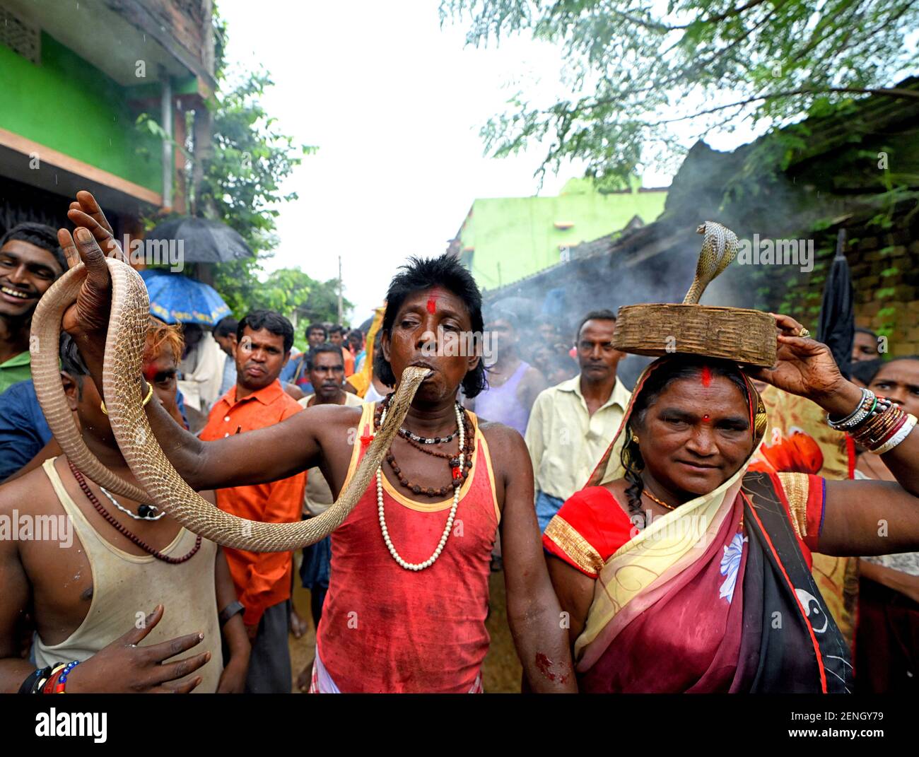 Snake Charmers and local villagers seen showing different tricks with ...