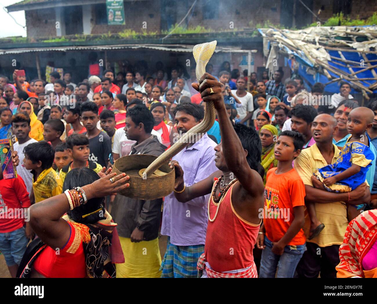A Snake Charmer and local villagers seen showing different tricks with ...