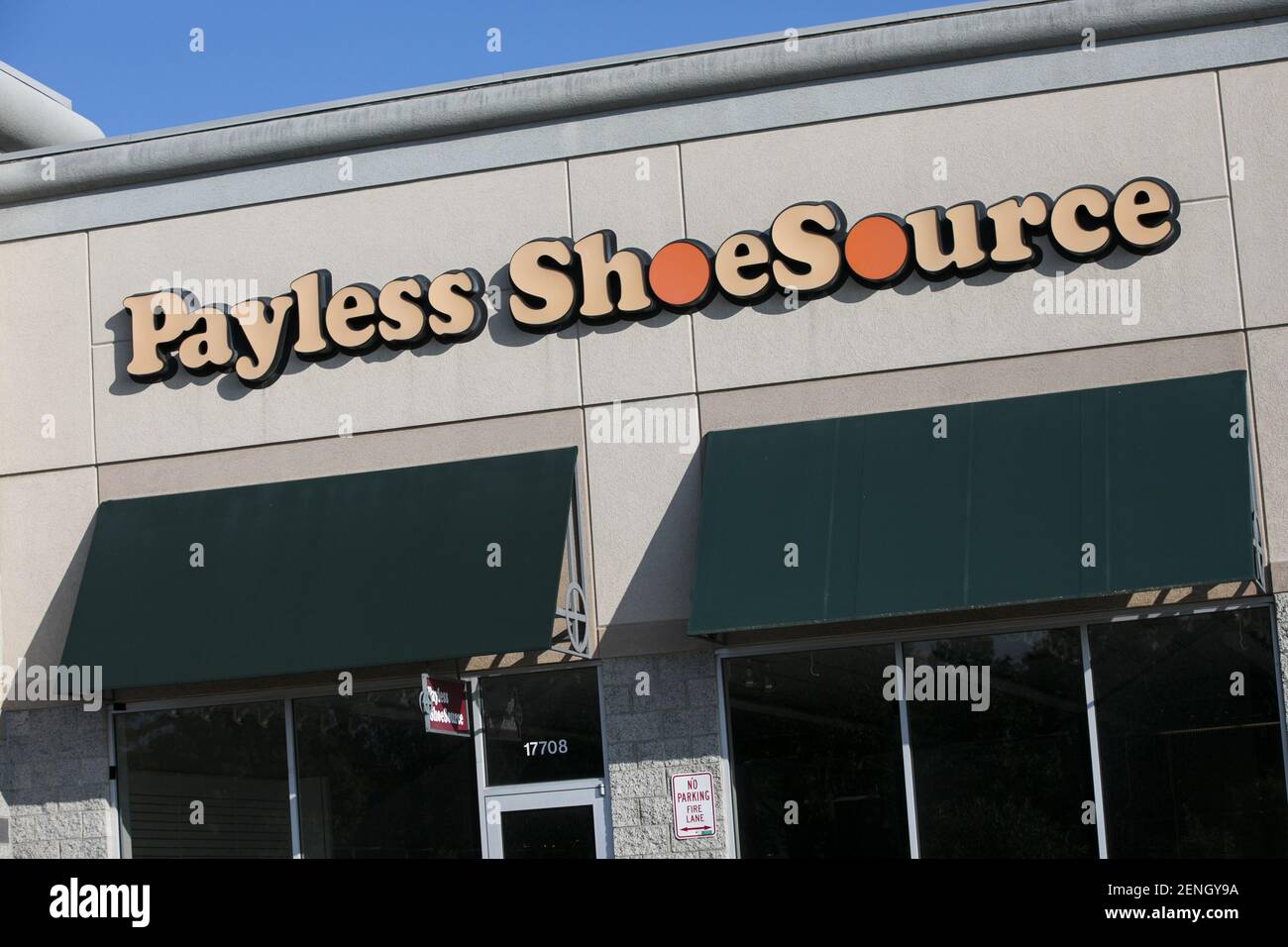 A logo sign outside of an abandoned Payless ShoeSource retail store ...
