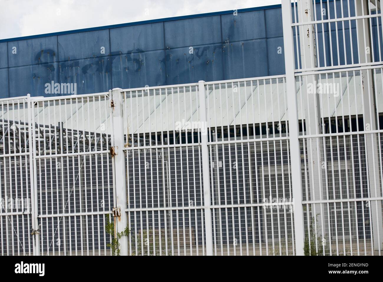 The faded outline of a logo sign outside of a closed and abandoned ...