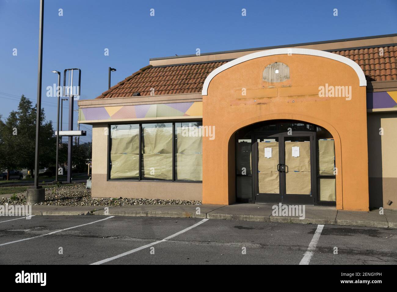 The faded outline of a logo sign outside of a closed and abandoned Taco ...