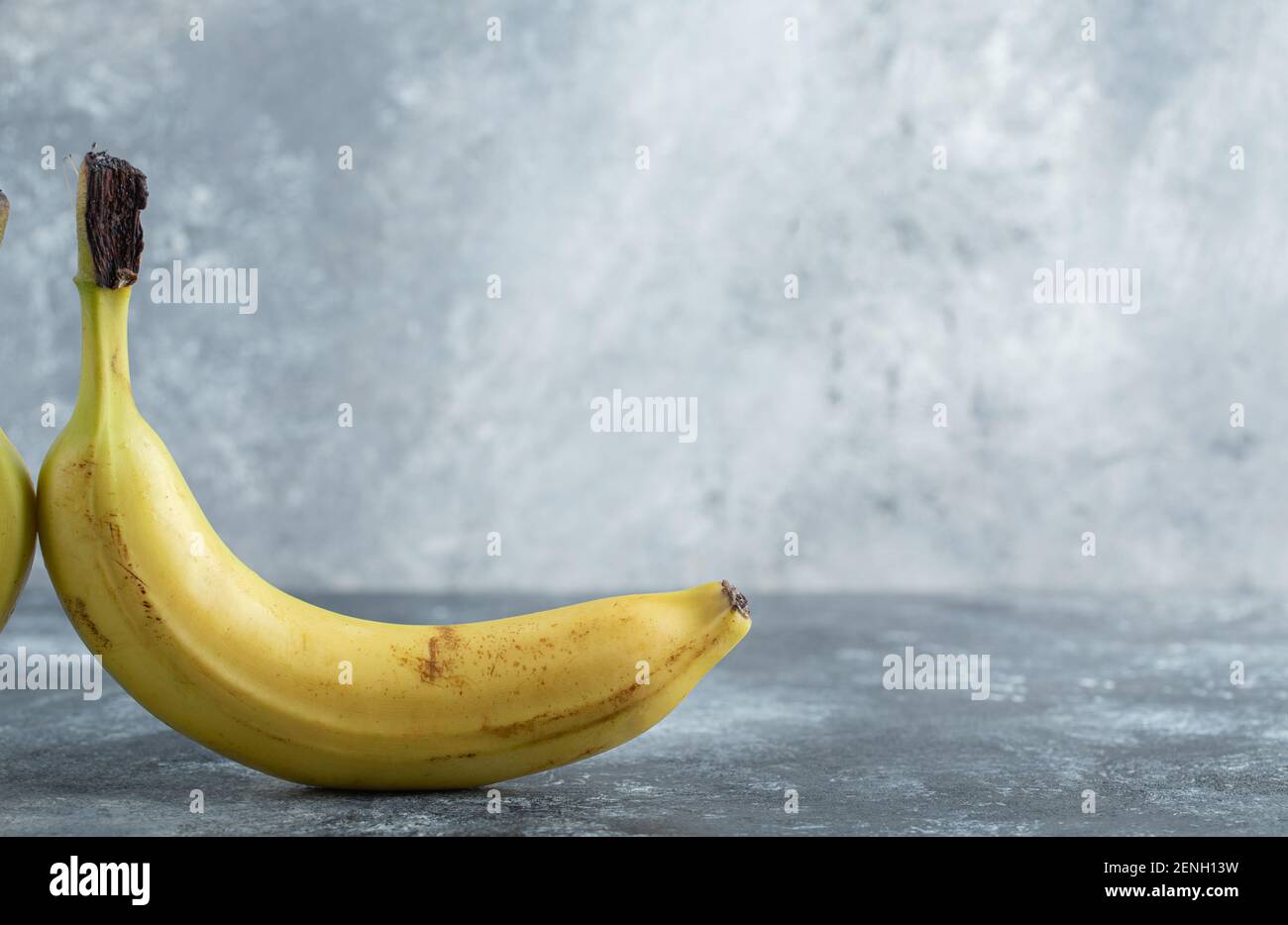 Photo of ripe yellow banana over grey background Stock Photo - Alamy